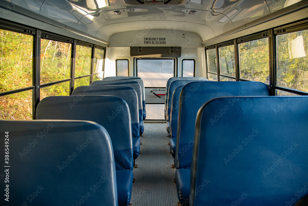Blue seats inside an empty short school bus Stock Photo | Adobe Stock