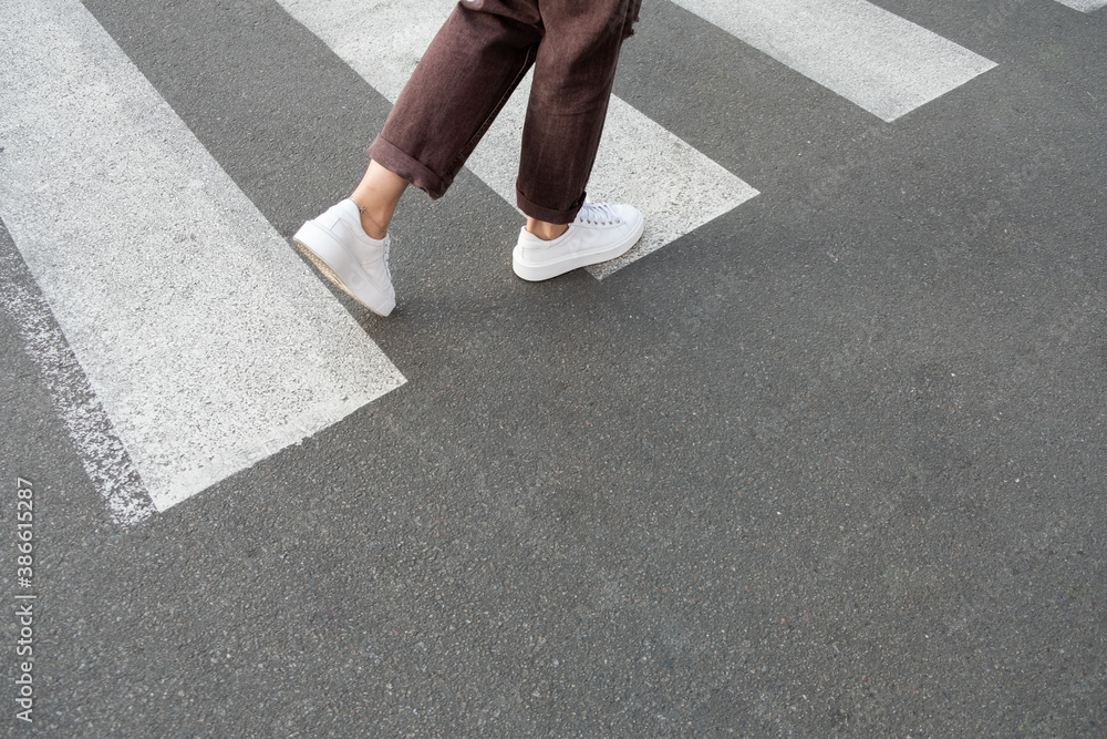 female feet crossing the crosswalk Stock Photo | Adobe Stock