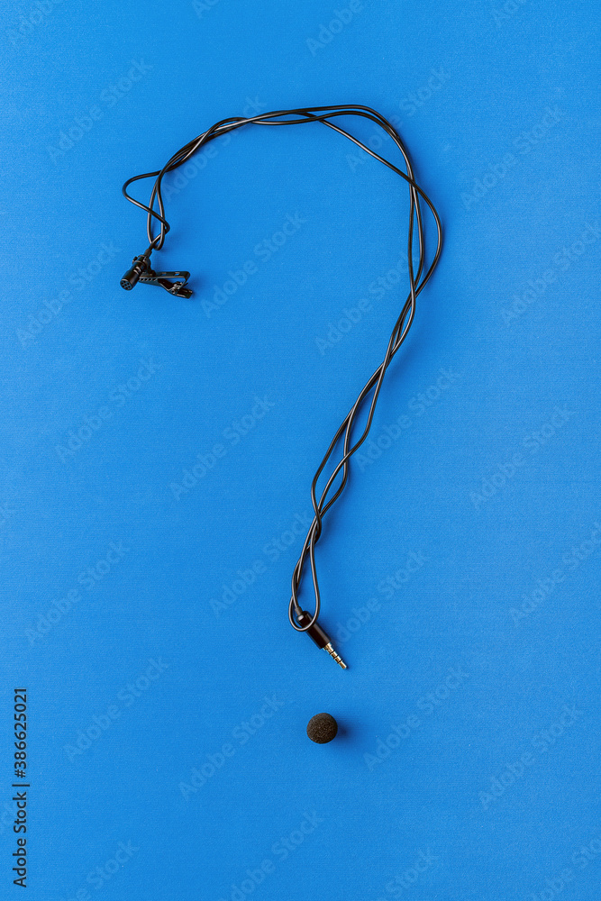 Body microphone lavalier twisted into a question mark. Conceptual ...