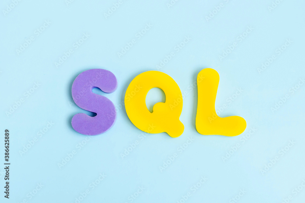 Structured Query Language. Word sql on blue background. Flat lay, top ...