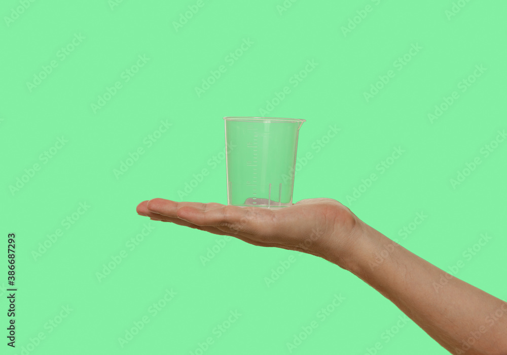 Hand holding measuring cup isolated on green screen background Stock ...