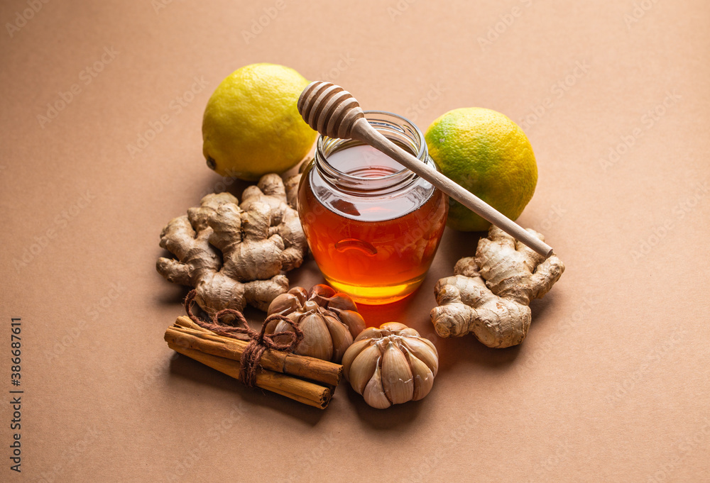 Natural cold and flu home remedies: honey glass pot, ginger, garlic ...