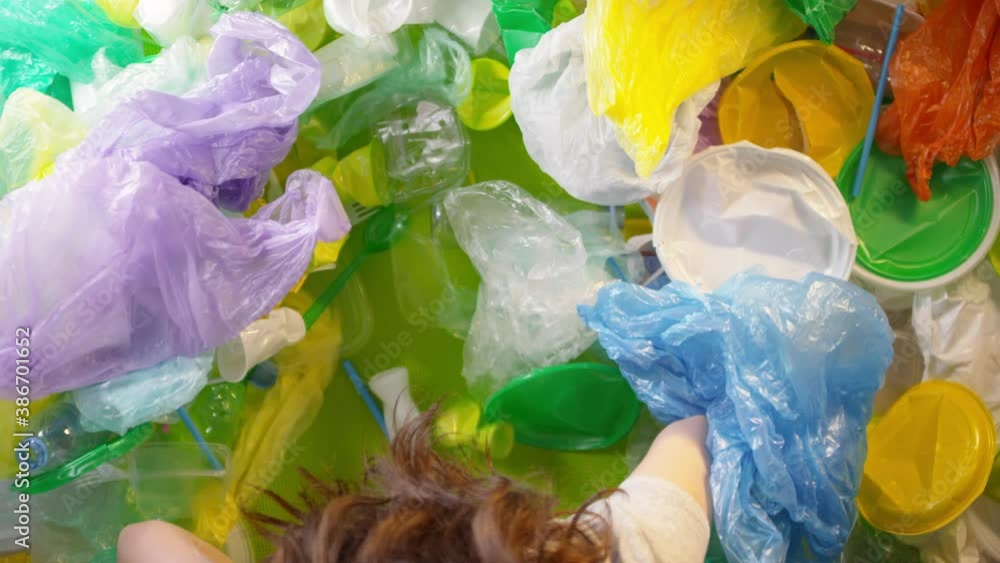 From above conceptual shot of young girl getting out of piles of ...