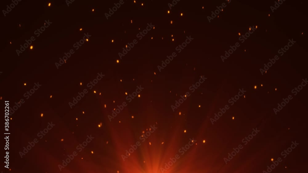 Abstract Burning red hot sparks rise from large fire in the night sky ...