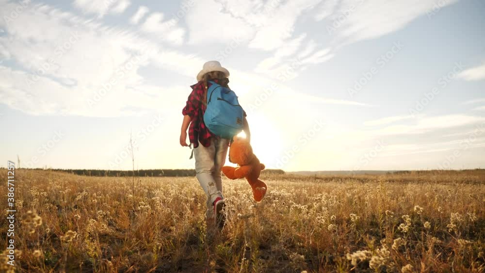 little girl child walk in the park a toy teddy bear. kid dream happy ...