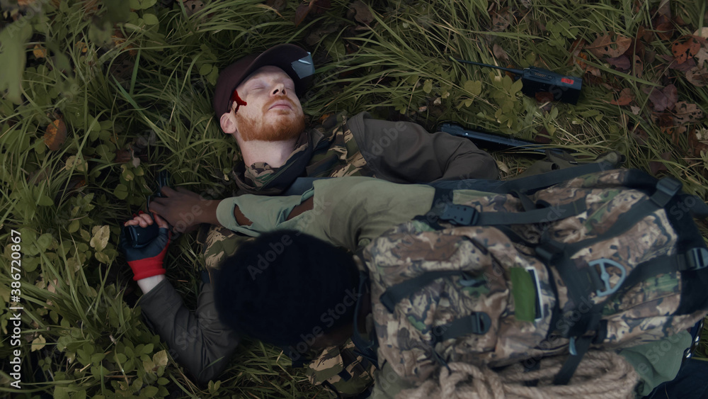 African man marauder finding dead body taking equipment and gun Stock ...