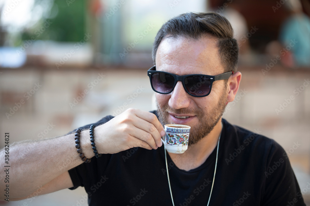 Young man drinking traditional turkish coffee in summer Stock Photo ...