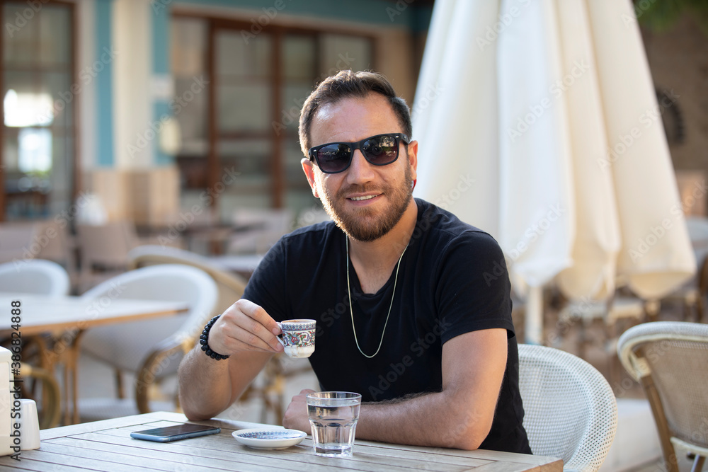 Young man drinking traditional turkish coffee in summer Stock Photo ...