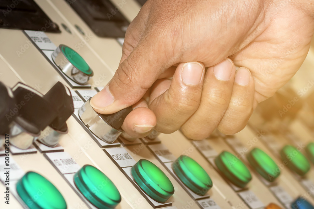 Hand of people key switch select mode in electrical control panel ...