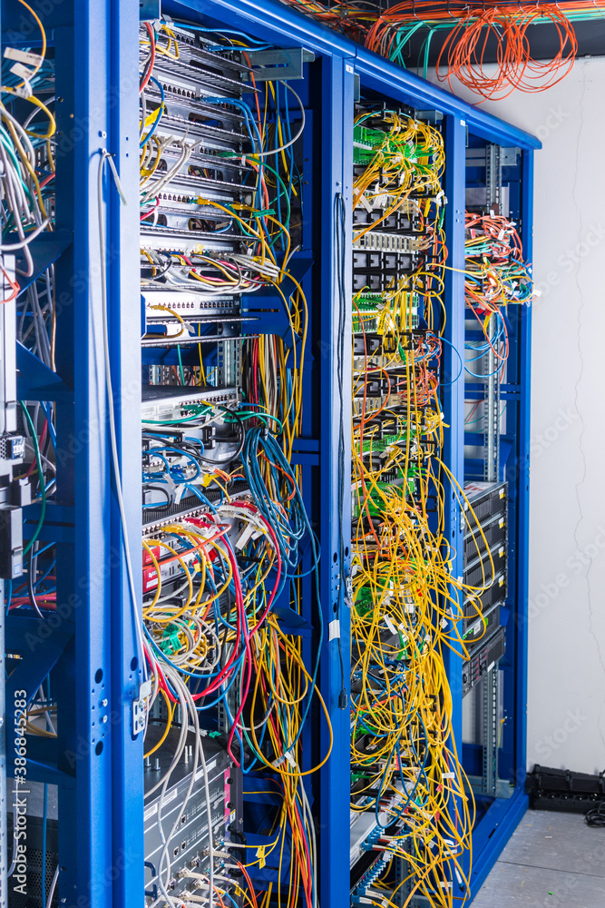 Server rack with fiber optic cables attached to front panel swit Stock ...