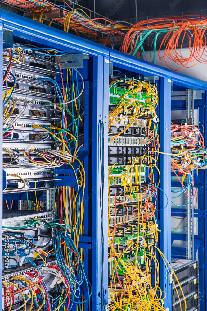 Server rack with fiber optic cables attached to front panel swit Stock ...