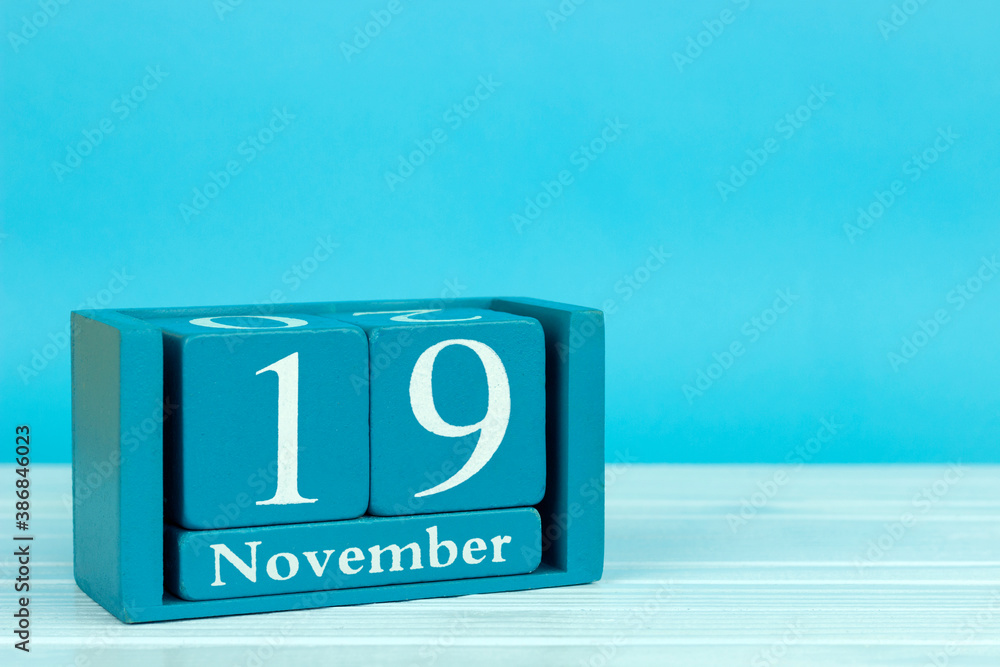 wooden calendar with the date of November 19 on a blue wooden ...