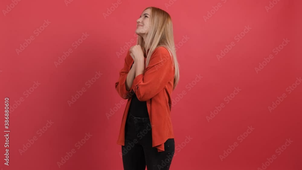 Happy cheerful female model with joyful expression, cheers and clenches ...