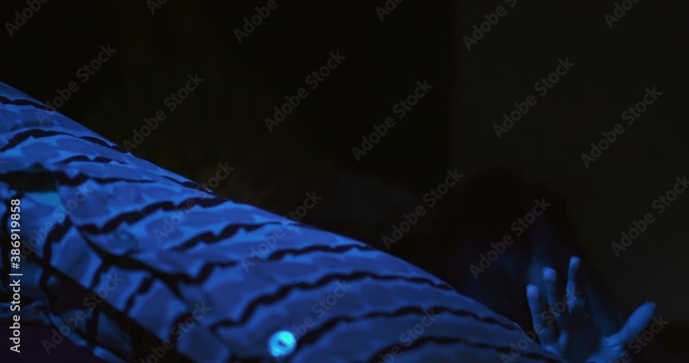 A nightmare monster dragging a young sleeping girl out of bed into the ...