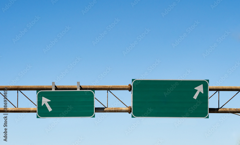 blank overhead highway signs in green and white with arrows pointing in ...