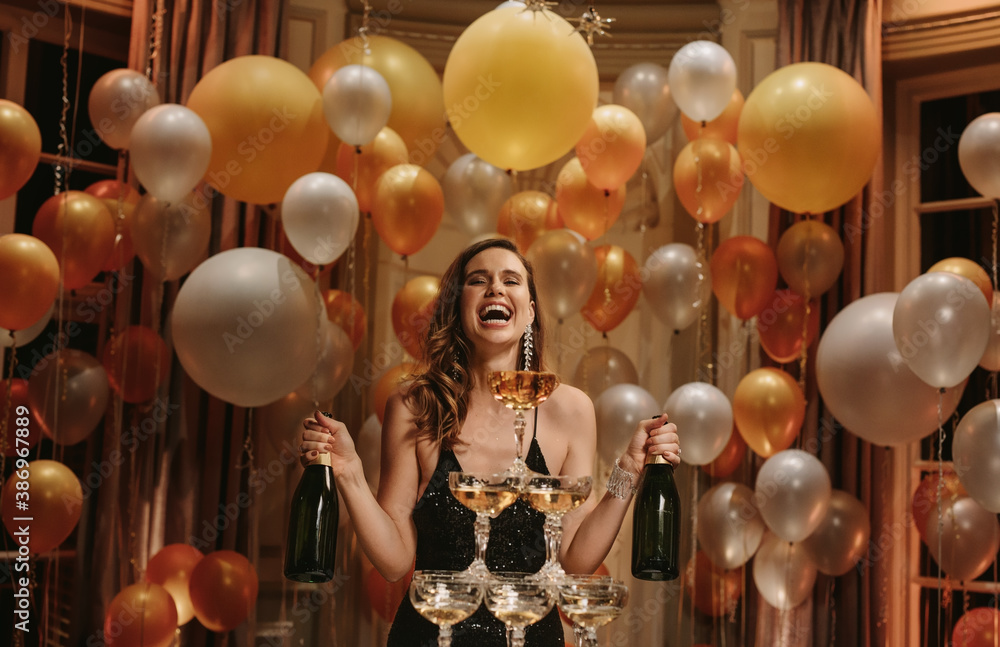 Pyramid of champagne glasses with a woman dancing Stock Photo | Adobe Stock