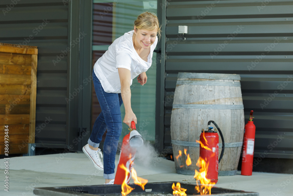 woman learning to use the fire extinguisher Stock Photo | Adobe Stock