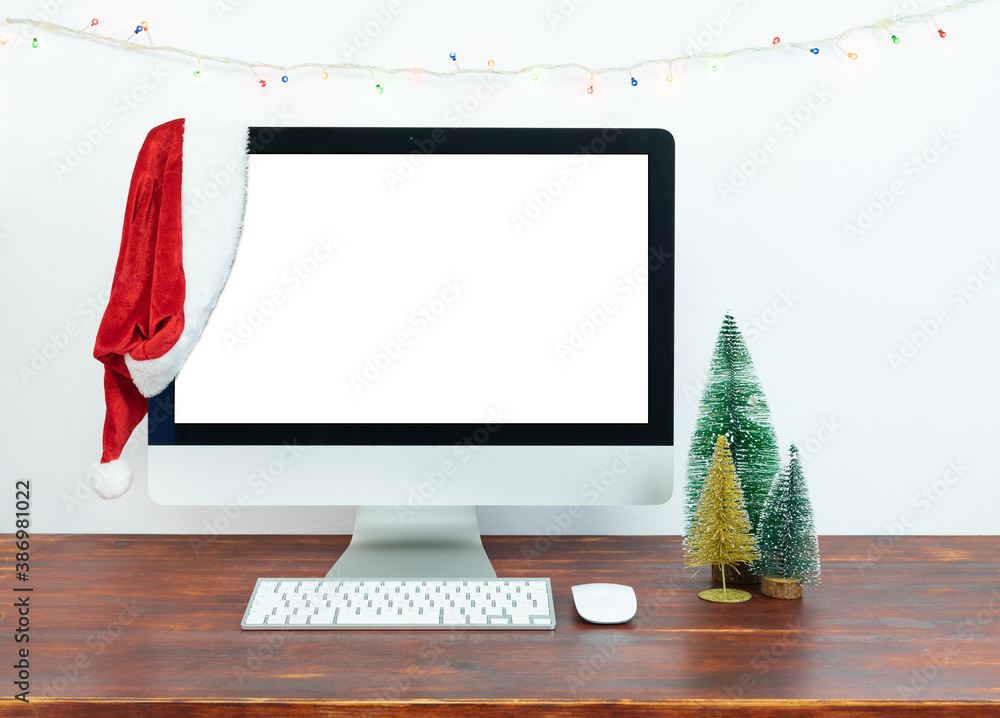 Computer with white screen on wooden desk with Christmas decoration ...