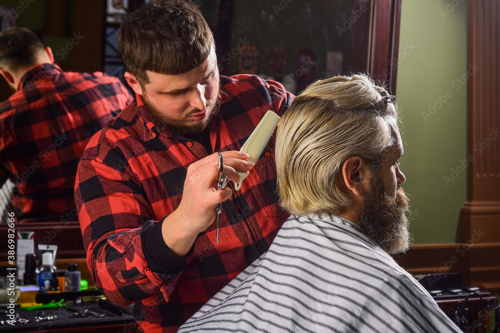 Barber hairstyle barbershop. Hipster getting haircut. Sharp object near ...