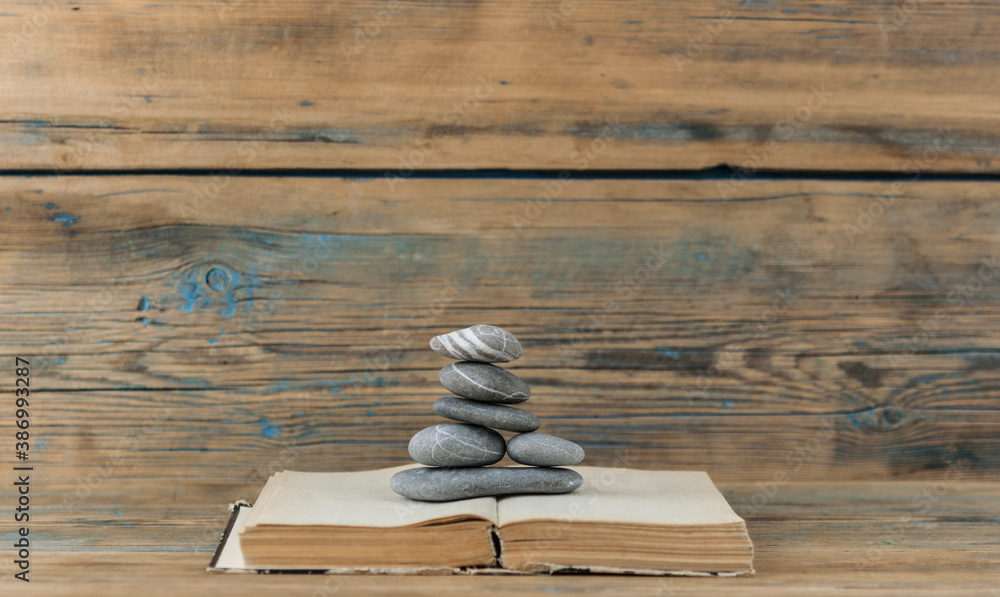 books and stack of zen stones on wood table background. Feng Shui ...