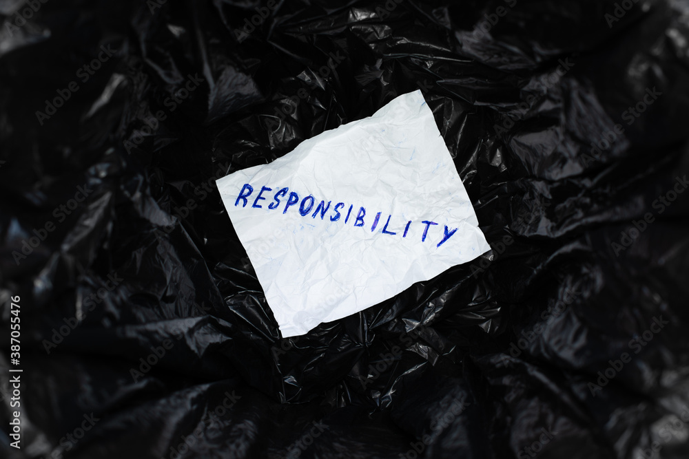 Crumpled white sheet of paper with word "Responsibility" on bottom of ...