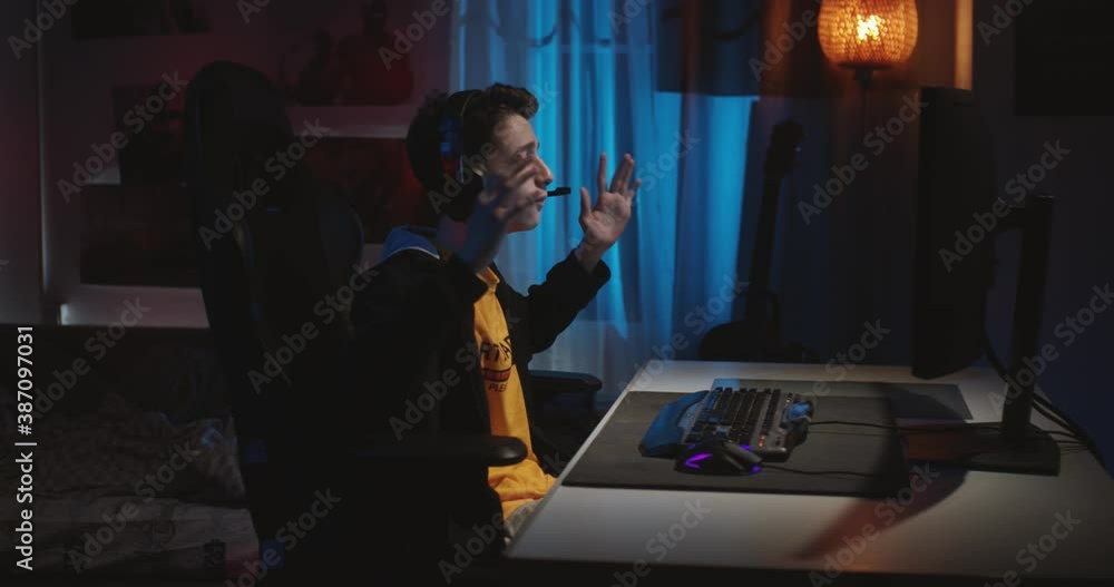 Teenage Gamer Having Fan Playing A Computer Game At Night And Then ...