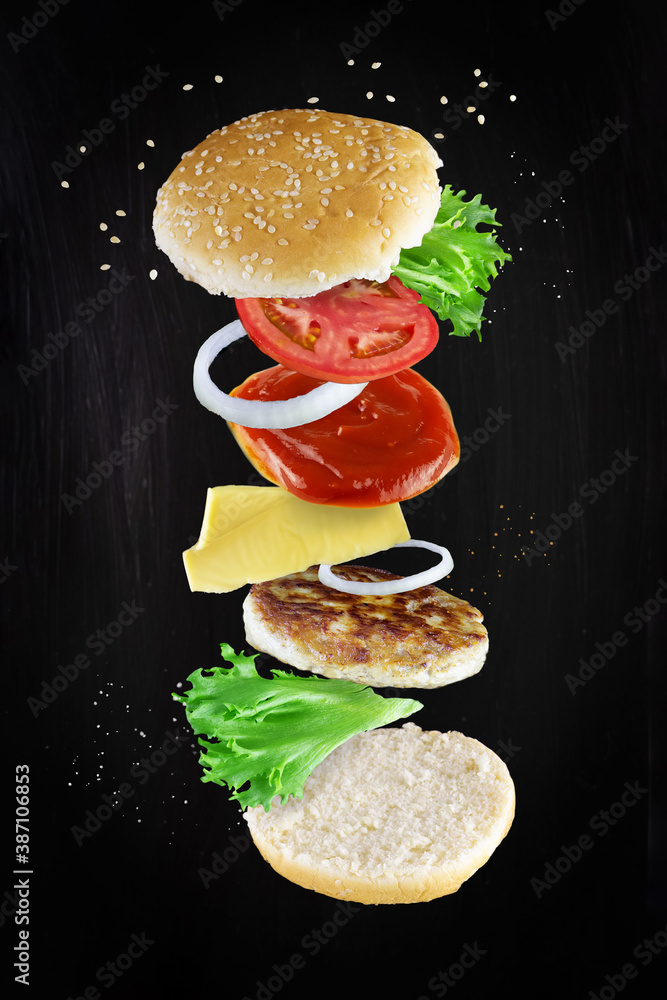 Levitating sandwich cheeseburger ingredients on dark background. Burger ...