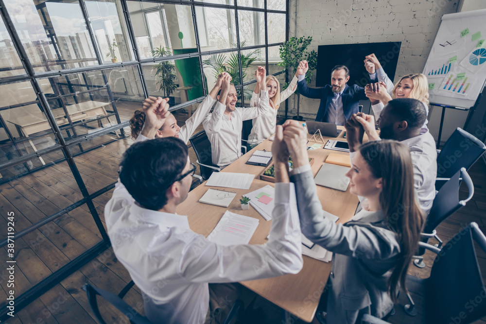 Nice stylish cheerful cheery managers staff gathering holding hands ...