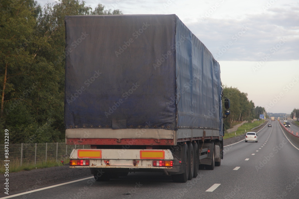European heavy truck with blue awning semi trailer van drive on left ...