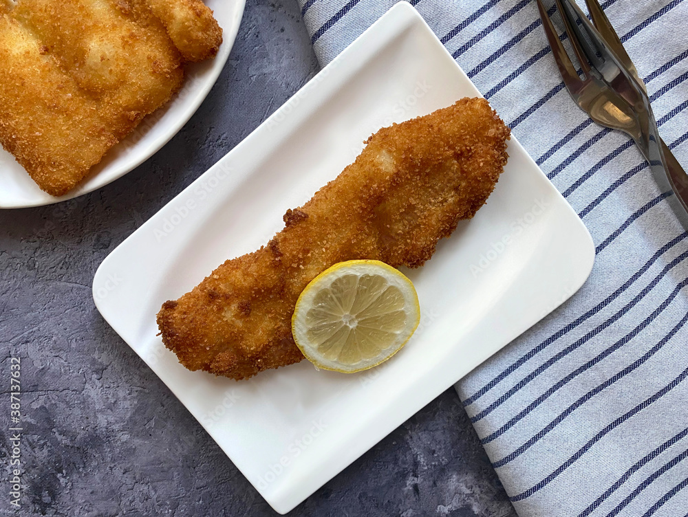 Breaded cod fish fillets, also known as Kabeljau. The fish is coated in ...