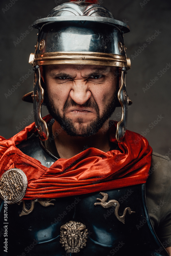 Mad and savage armoured roman soldier dressed in black armour and red ...