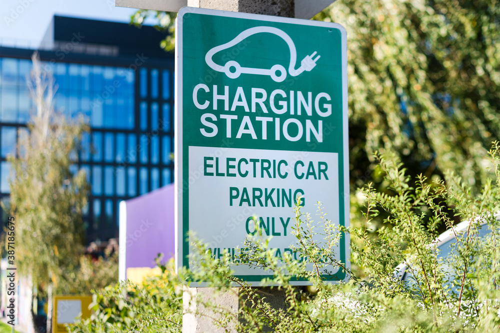 Electric car road sign charging station. Outdoor car parking and ...