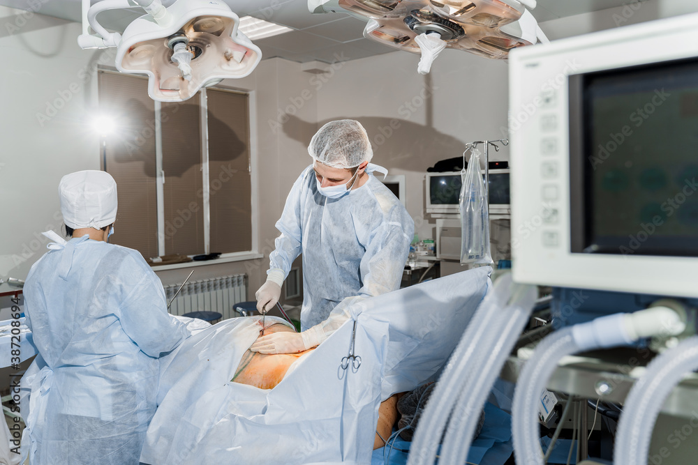 Surgeon removes fat in the gluteal region. Abdominoplasty - plastic ...
