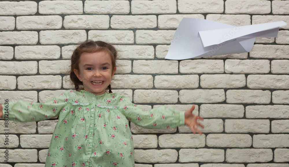 The little girl threw up the documents, laughing. Child in the office ...