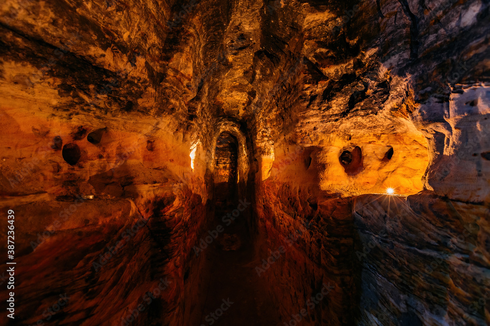 Ancient narrow underground passage in sandstone at old underground ...