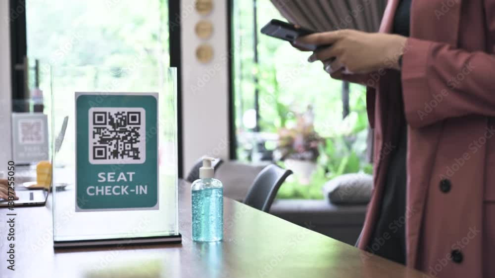 Asian female scan check-in QR code by smartphone app and cleansing hand ...