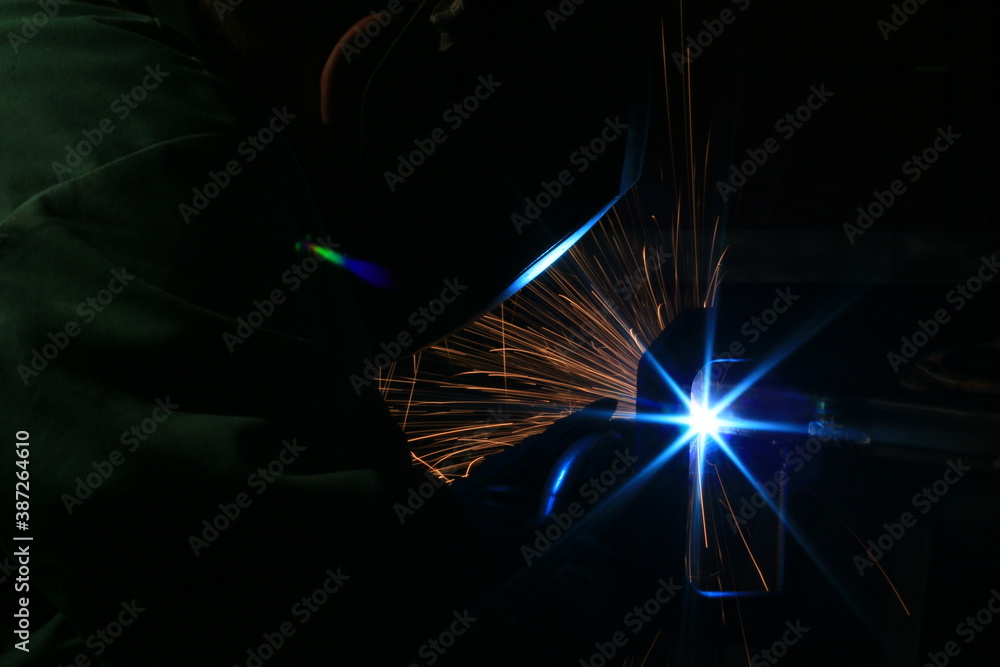 Welding background,with orange sparks and blue lens flare. Fabrication ...