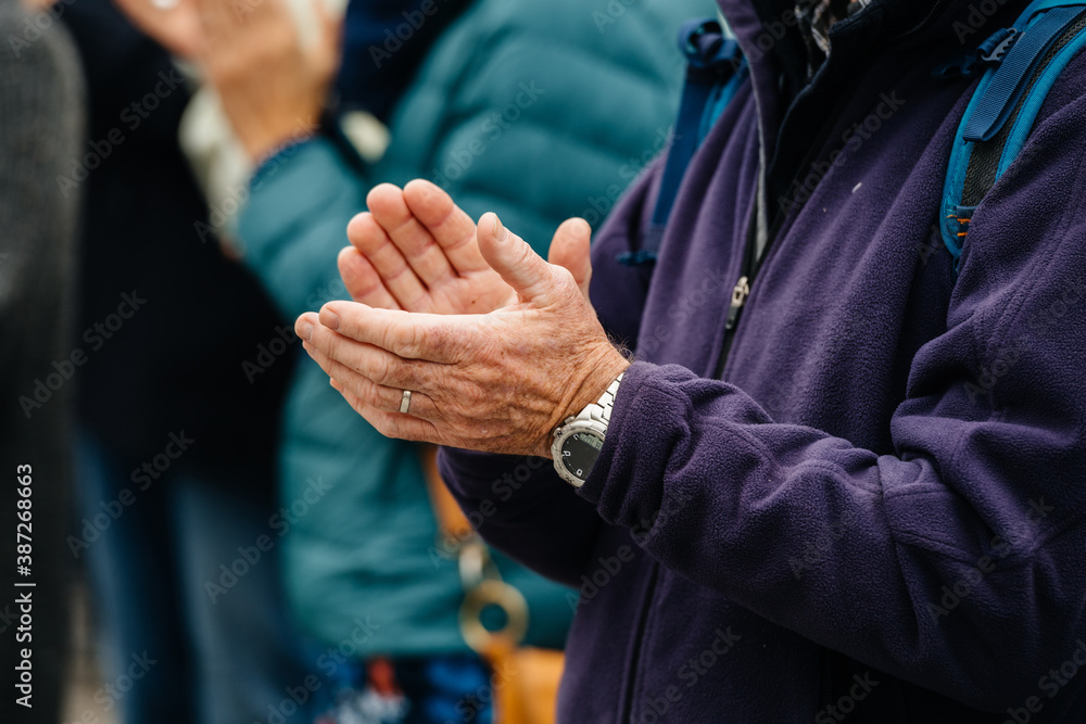 Senior man hand clapping at the Place Kleber to pay tribute to history ...