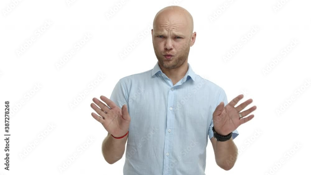 Reluctant bald guy with beard, wearing blue shirt, saying no and ...