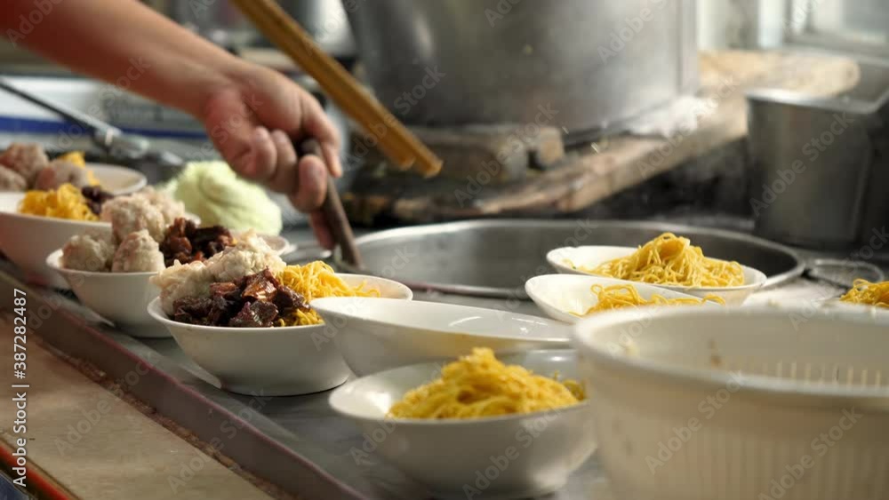 Traditional cooking of beef wonton noodle soup in Chinese kitchen, in ...