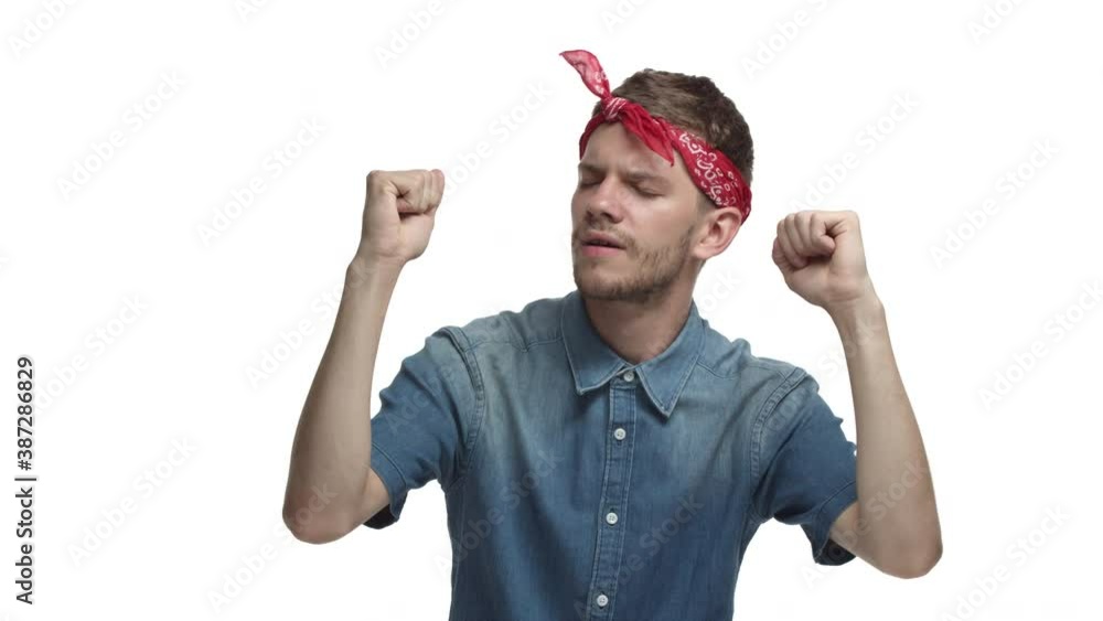 Video of handsome hipster guy with red headband over forehead, dancing ...