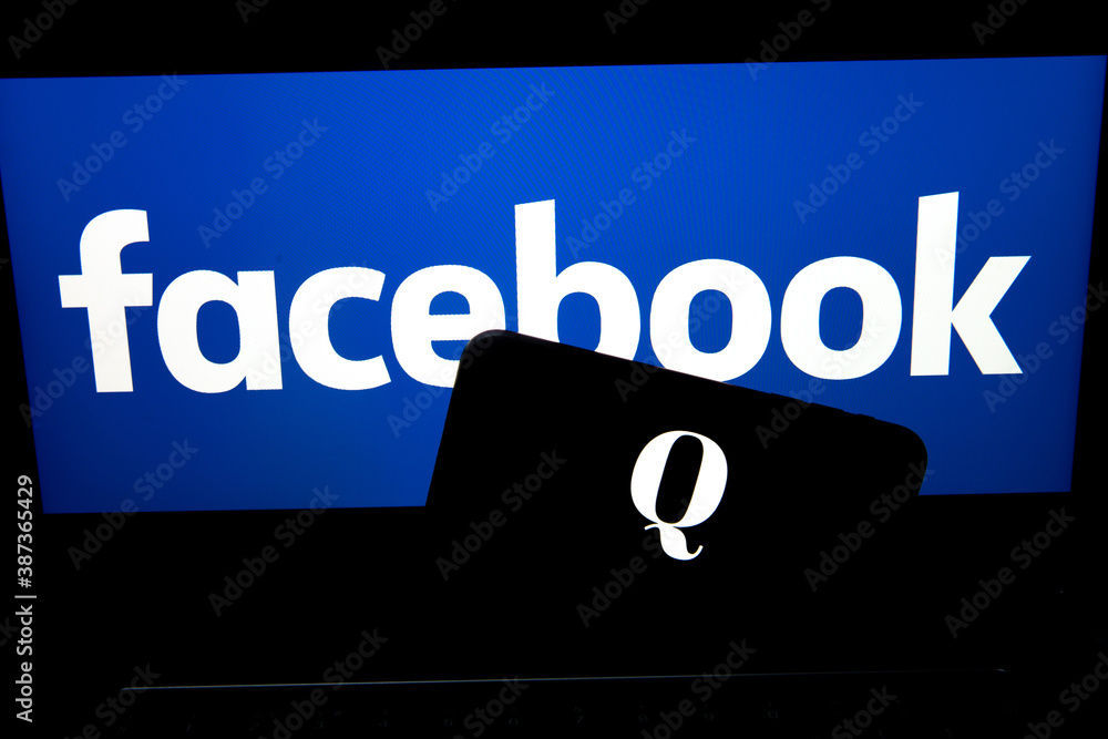 QAnon vs FACEBOOK. QAnon organization logo seen on the smartphone which ...