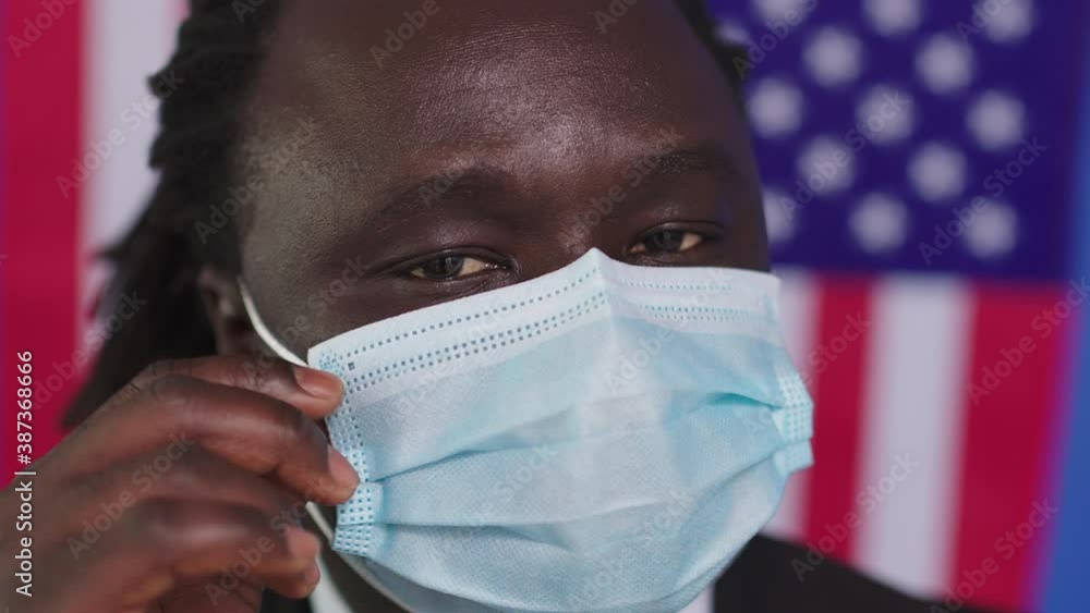 Close Up of Black Man Checking His Face Mask In Front of American ...