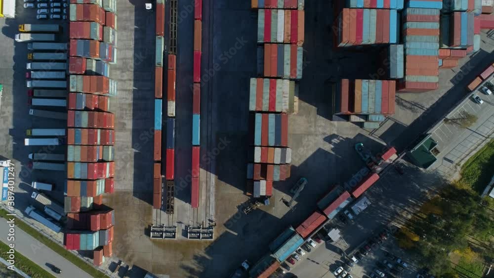 Overhead drone footage of shipping containers with transport network ...