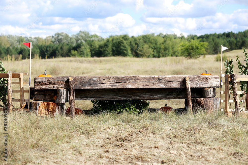 Jumping horse log obstacle on cross country course without riders as a ...