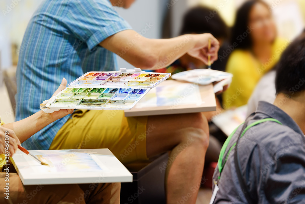 Activities of an elderly woman painting watercolor on her drawing with ...