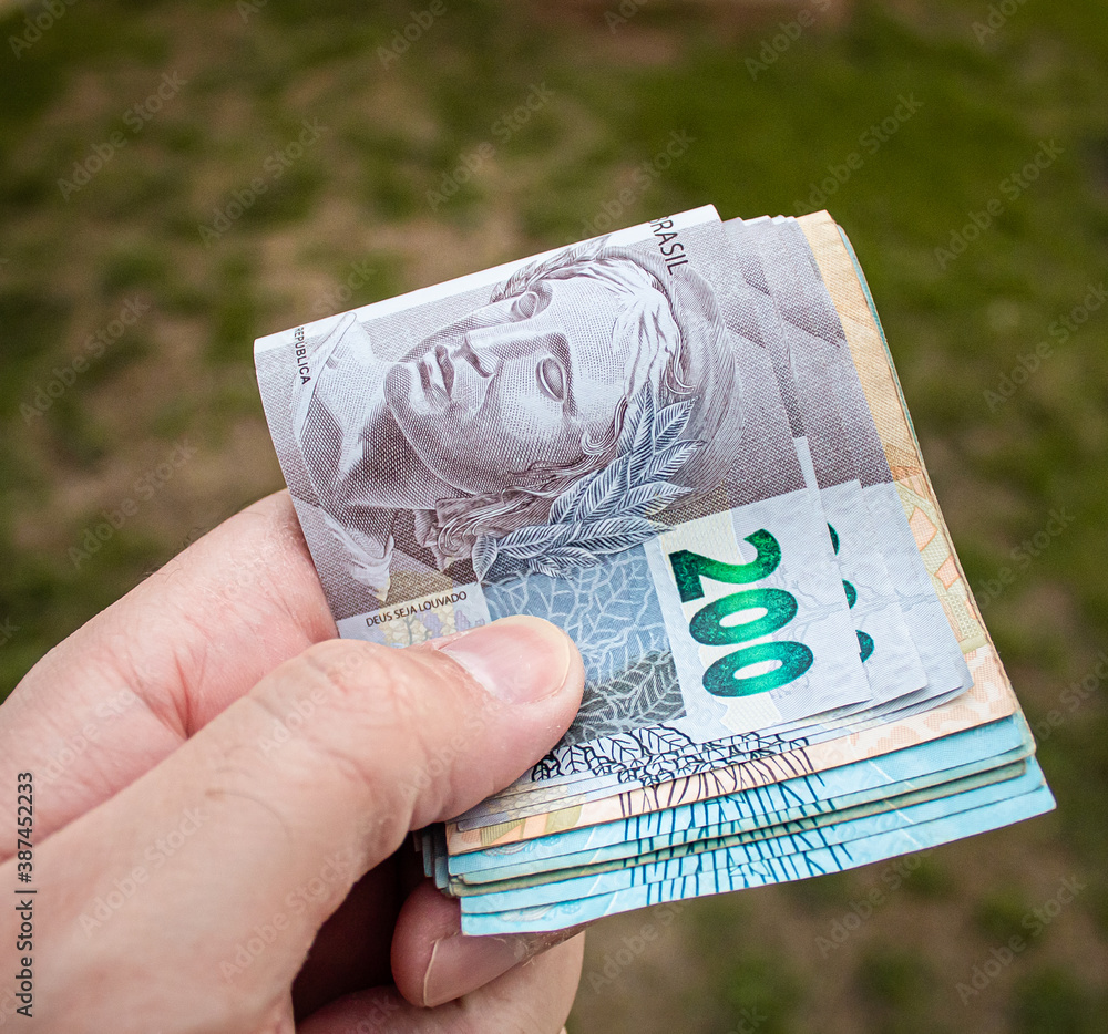 Dinheiro, Brasil, Reais, Real Brasileiro, Real. Uma pessoa segurando um ...