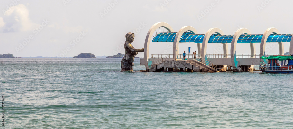 Rayong, Thailand - 21 October 2015: Pier to Koh Samet and statue of god ...