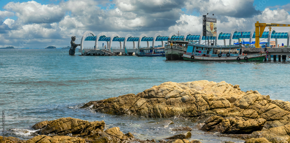 Rayong, Thailand - 21 October 2015: Pier to Koh Samet and statue of god ...
