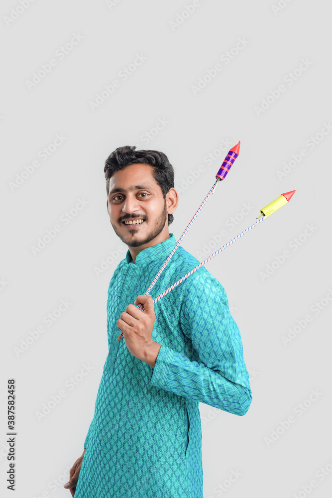 Diwali festival concept, Young Indian man in ethnic wear and holding ...